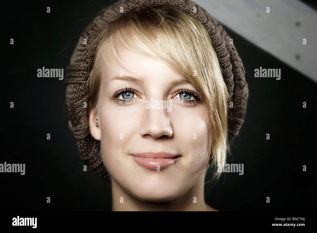 Portrait of a young woman with a knitted cap, direct look, cool, young ...