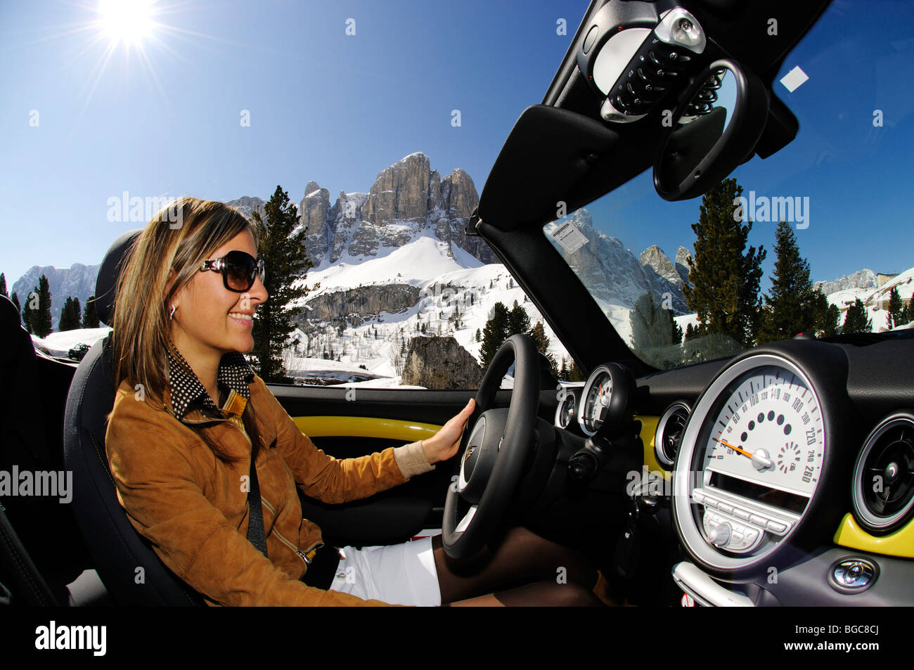 Woman driving Mini Cooper at the Gardena Pass, Alpine pass, South Stock ...