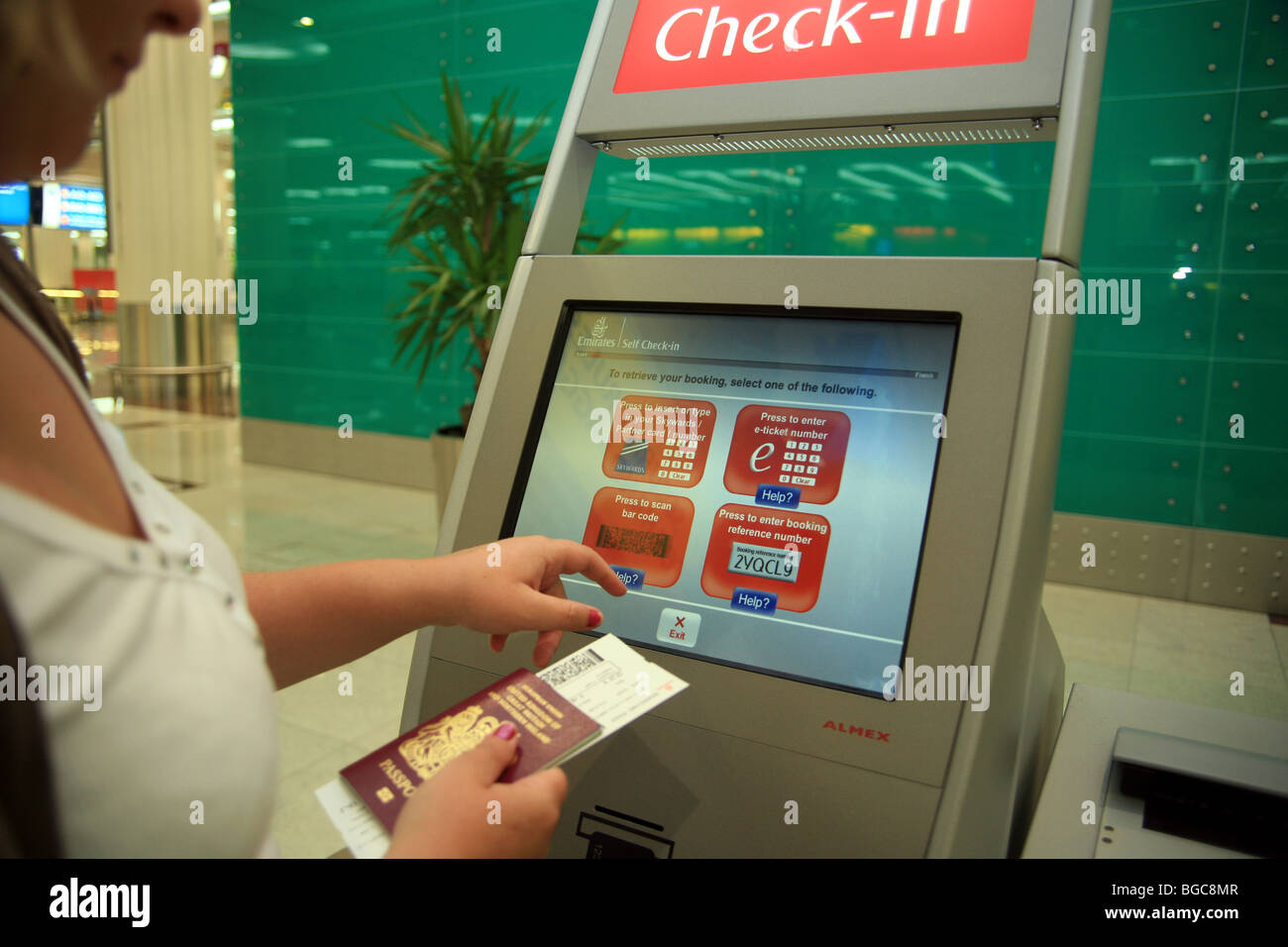 Self-check in and using a passport scanner at Dubai Airport Stock Photo ...