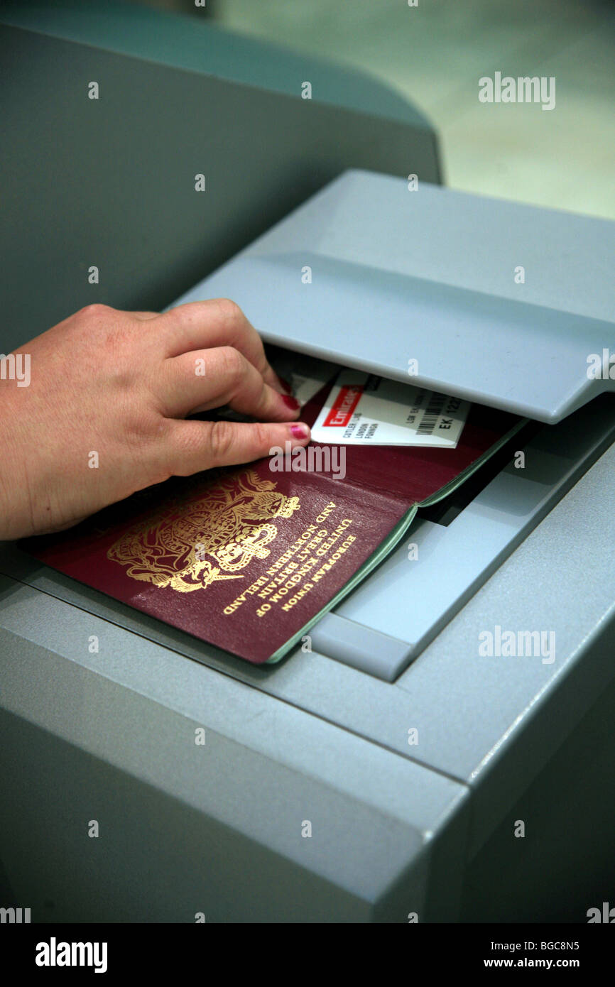 Self-check in and using a passport scanner at Dubai Airport Stock Photo ...