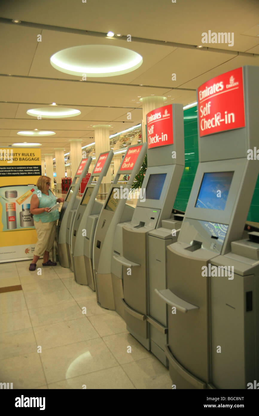 Self-check in and using a passport scanner at Dubai Airport Stock Photo ...