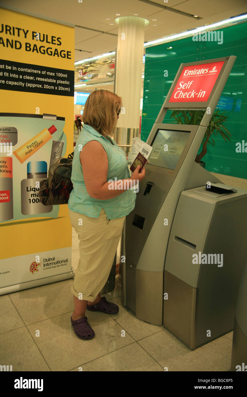 Self-check in and using a passport scanner at Dubai Airport Stock Photo ...