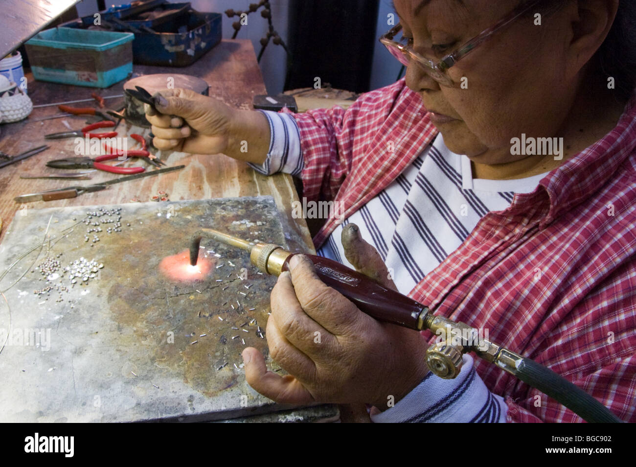 native American making jewelry Stock Photo - Alamy