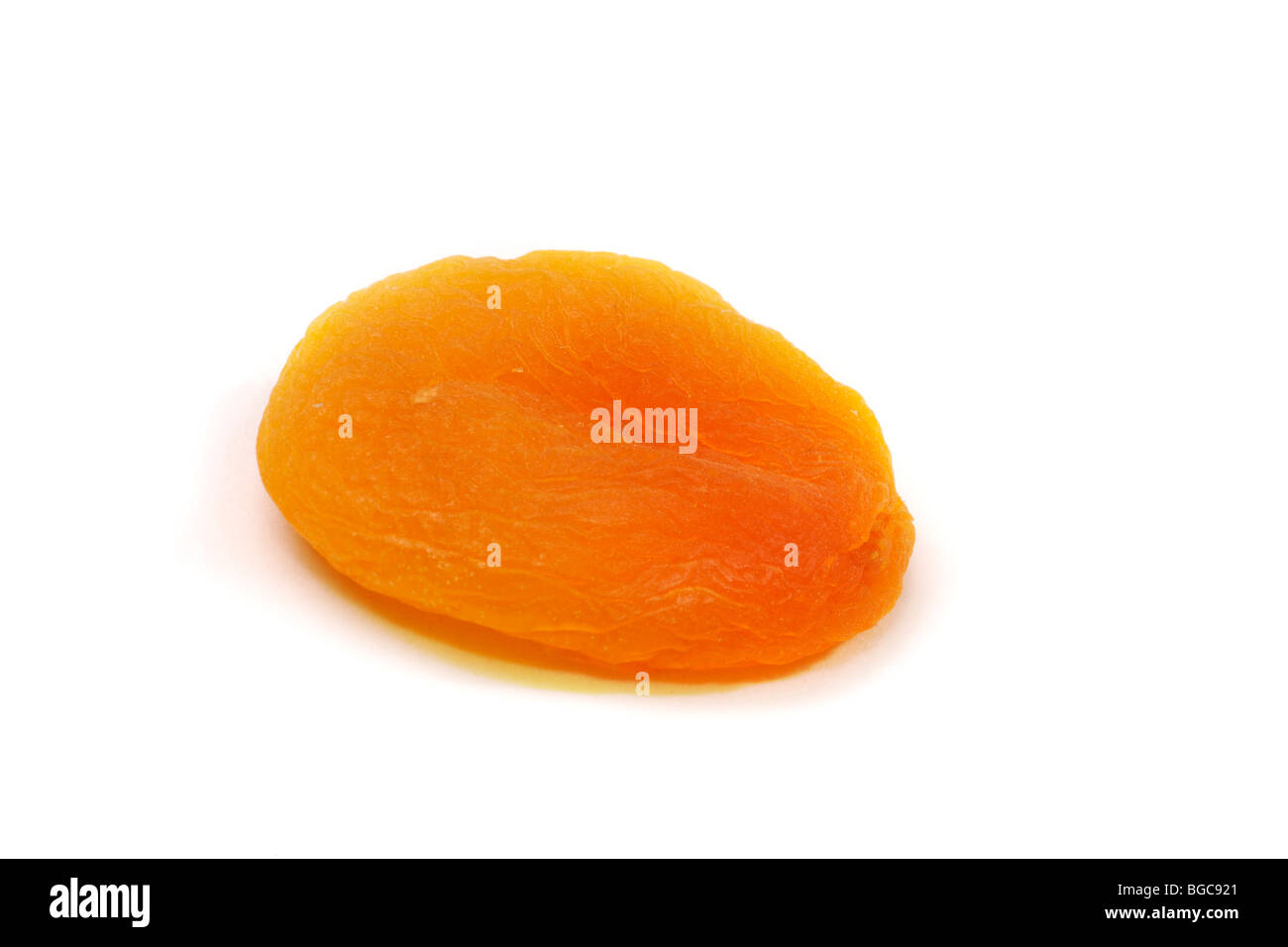 Single dried apricot on white background Stock Photo - Alamy