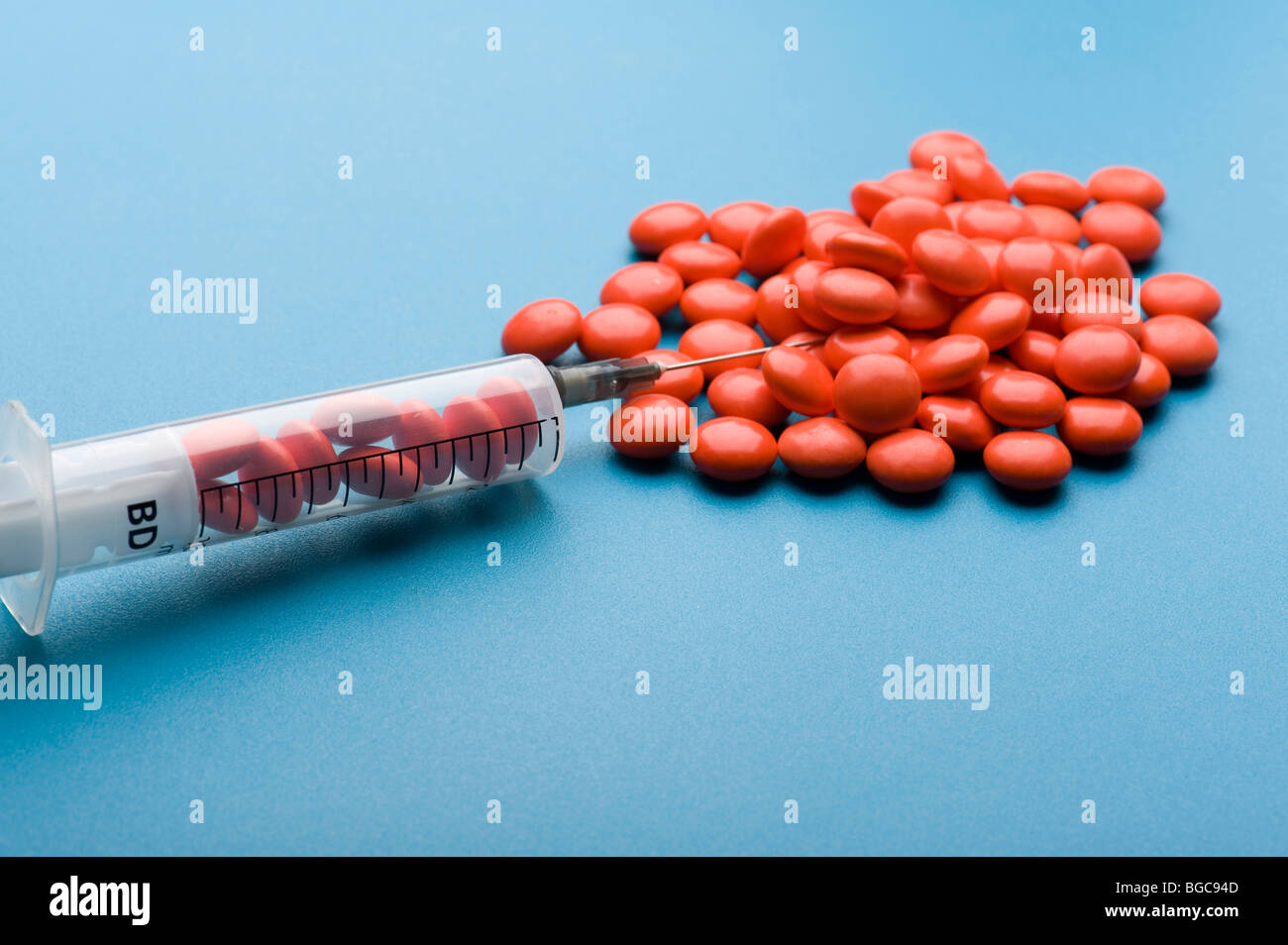 object on blue - medical Tablet and syringe Stock Photo - Alamy