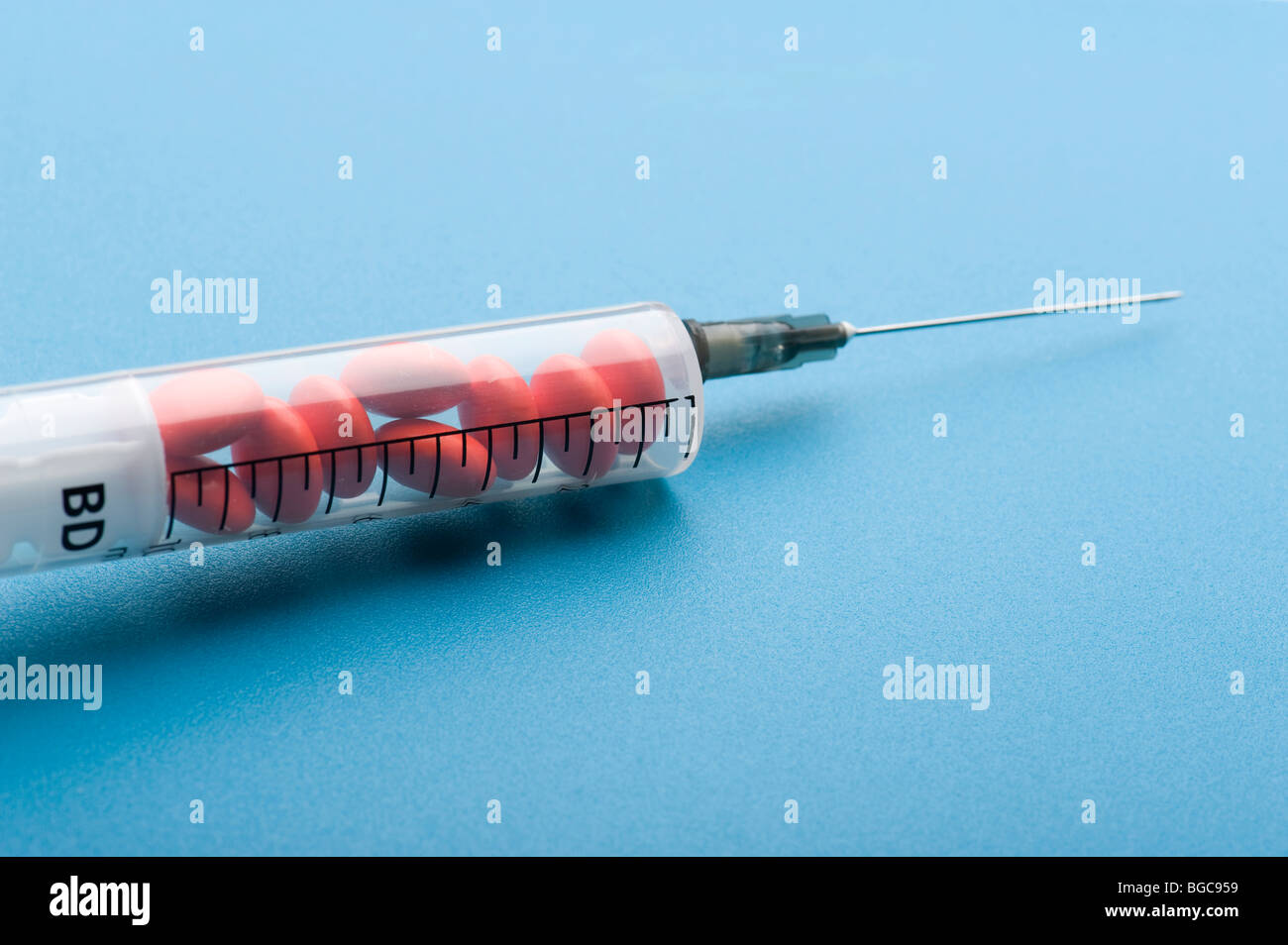 object on blue - medical Tablet and syringe Stock Photo - Alamy