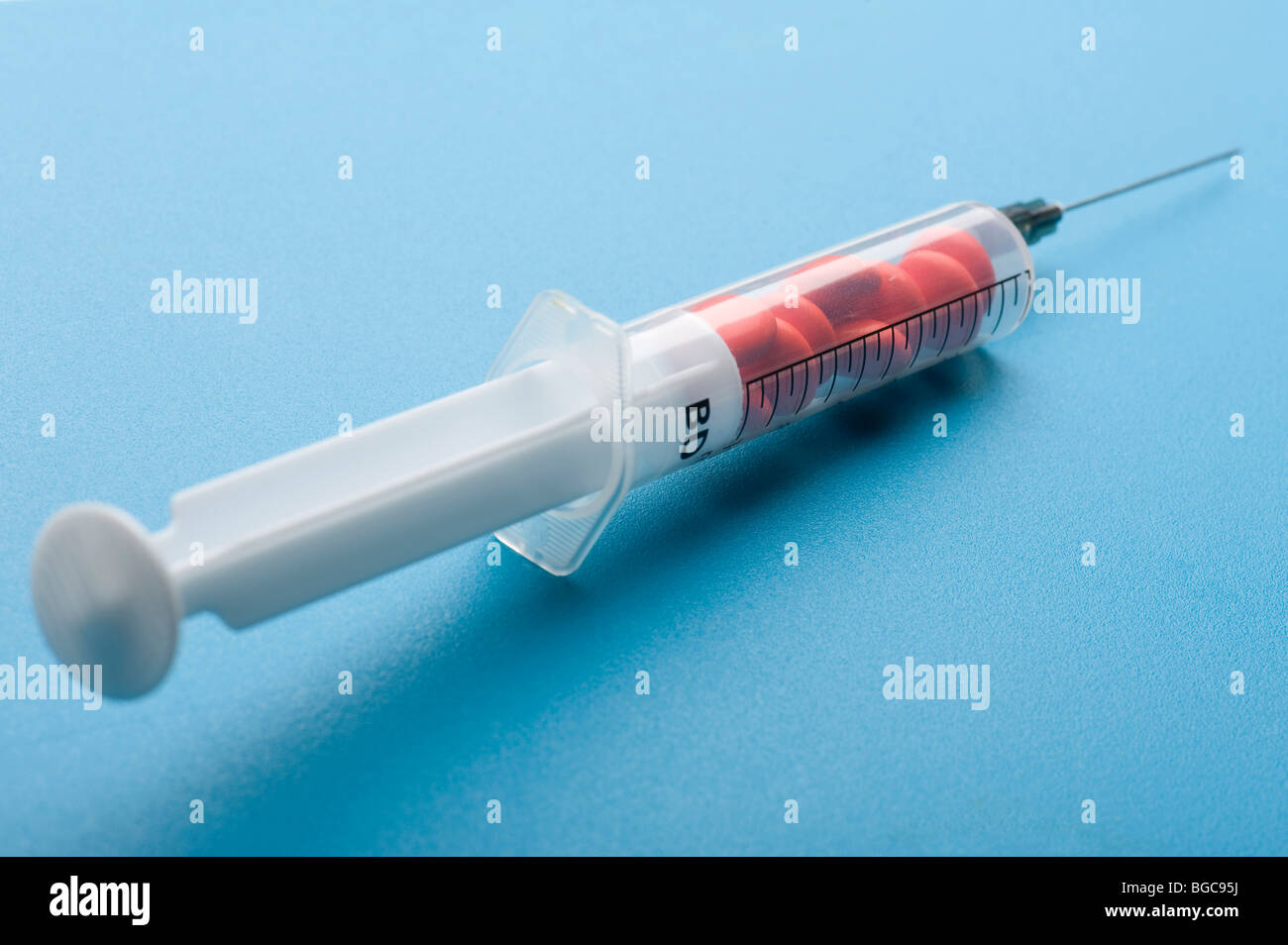 object on blue - medical Tablet and syringe Stock Photo - Alamy