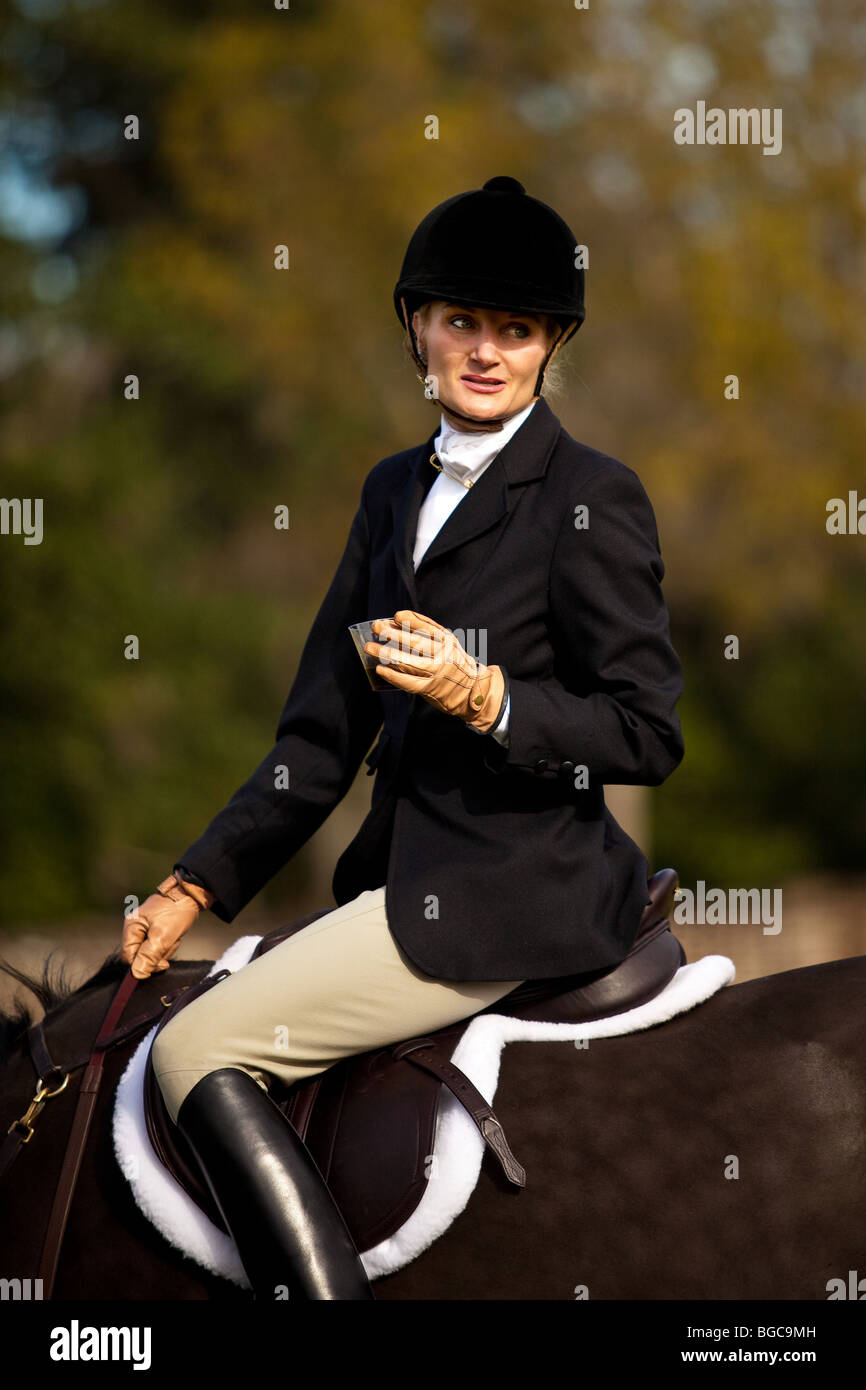 A fox hunter before the start of the foxhunt on the greensward of ...