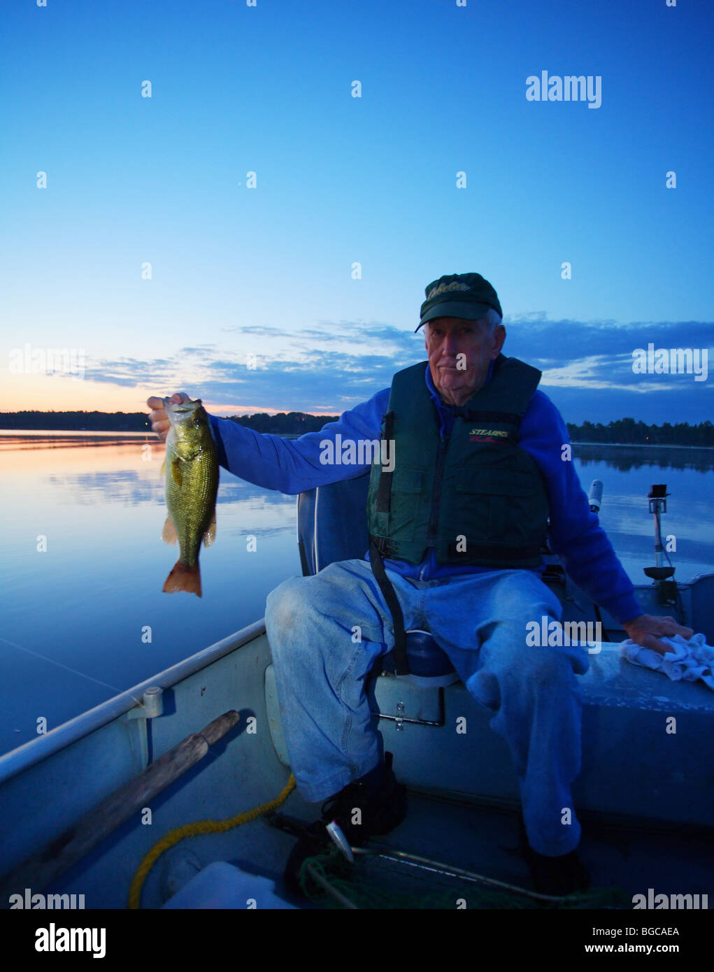 senior elderly fishing guide fisherman holding up monster five 5 pound ...