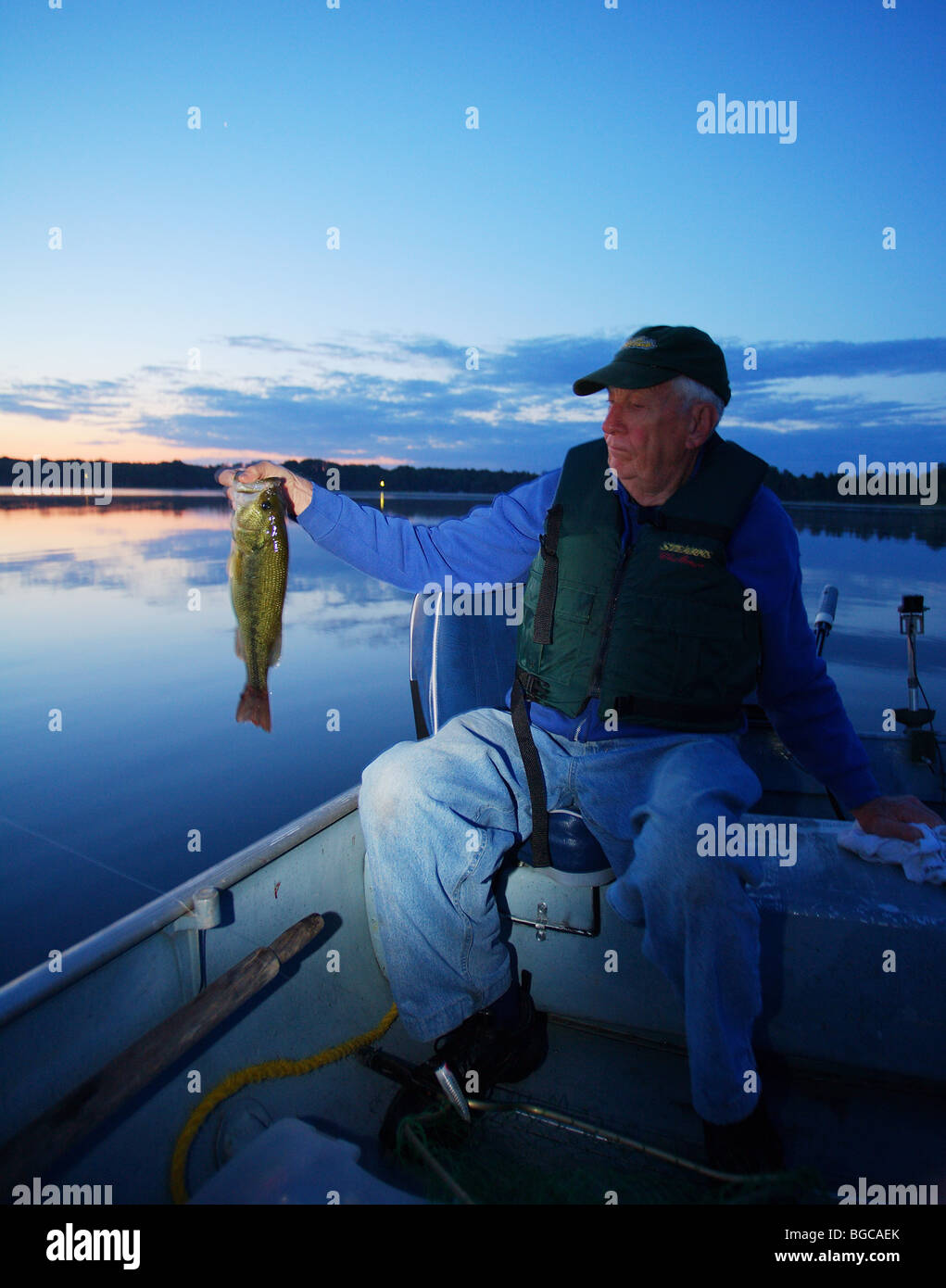 senior elderly fishing guide fisherman holding up monster five 5 pound ...