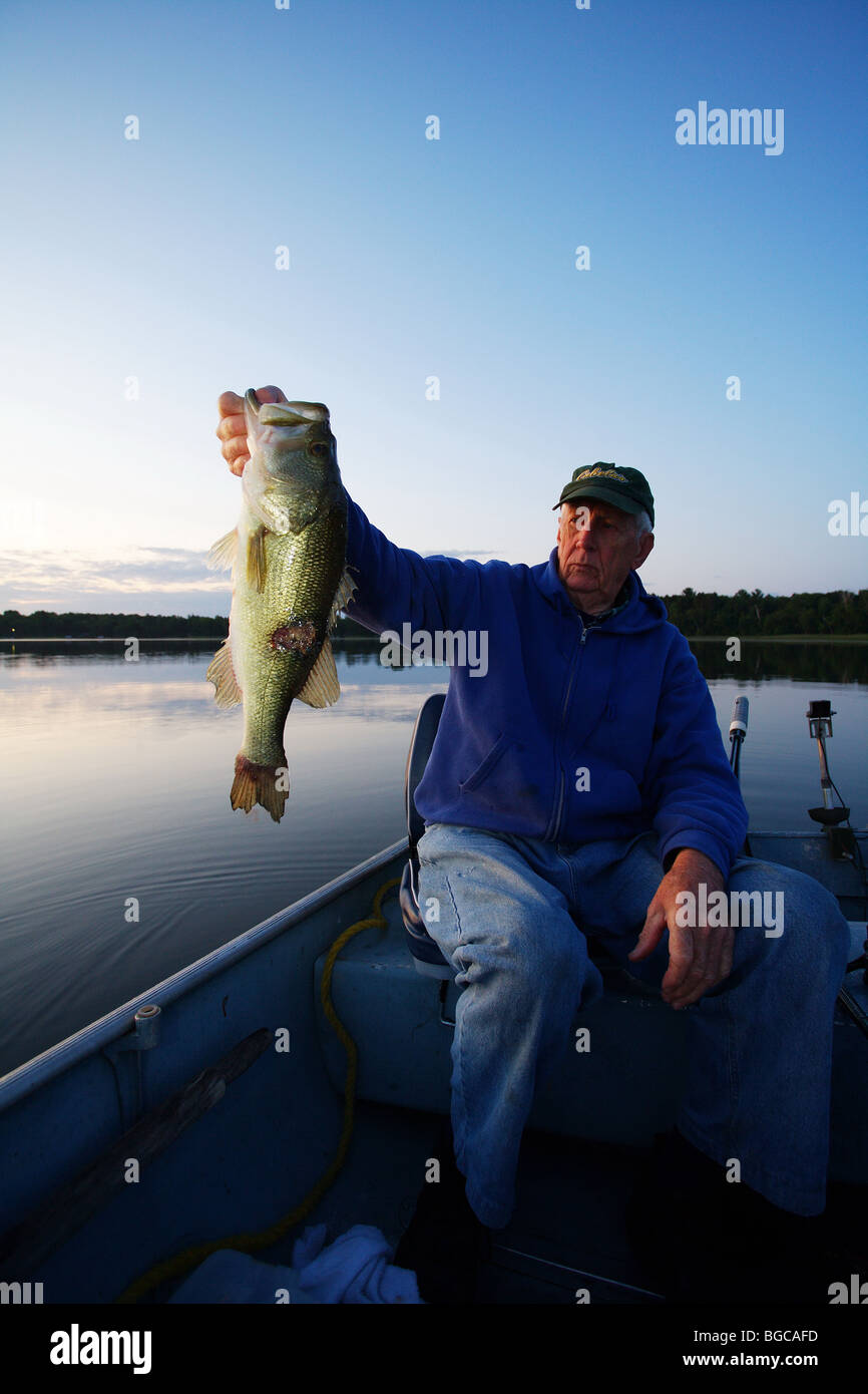 senior elderly fishing guide fisherman holding up monster five 5 pound ...
