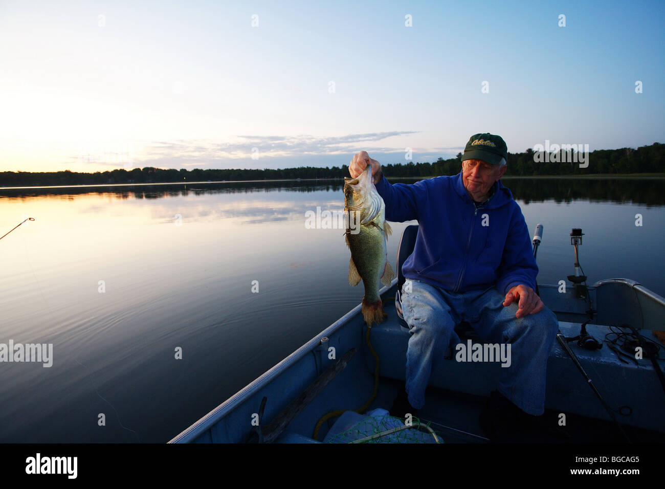 senior elderly fishing guide fisherman holding up monster five 5 pound ...