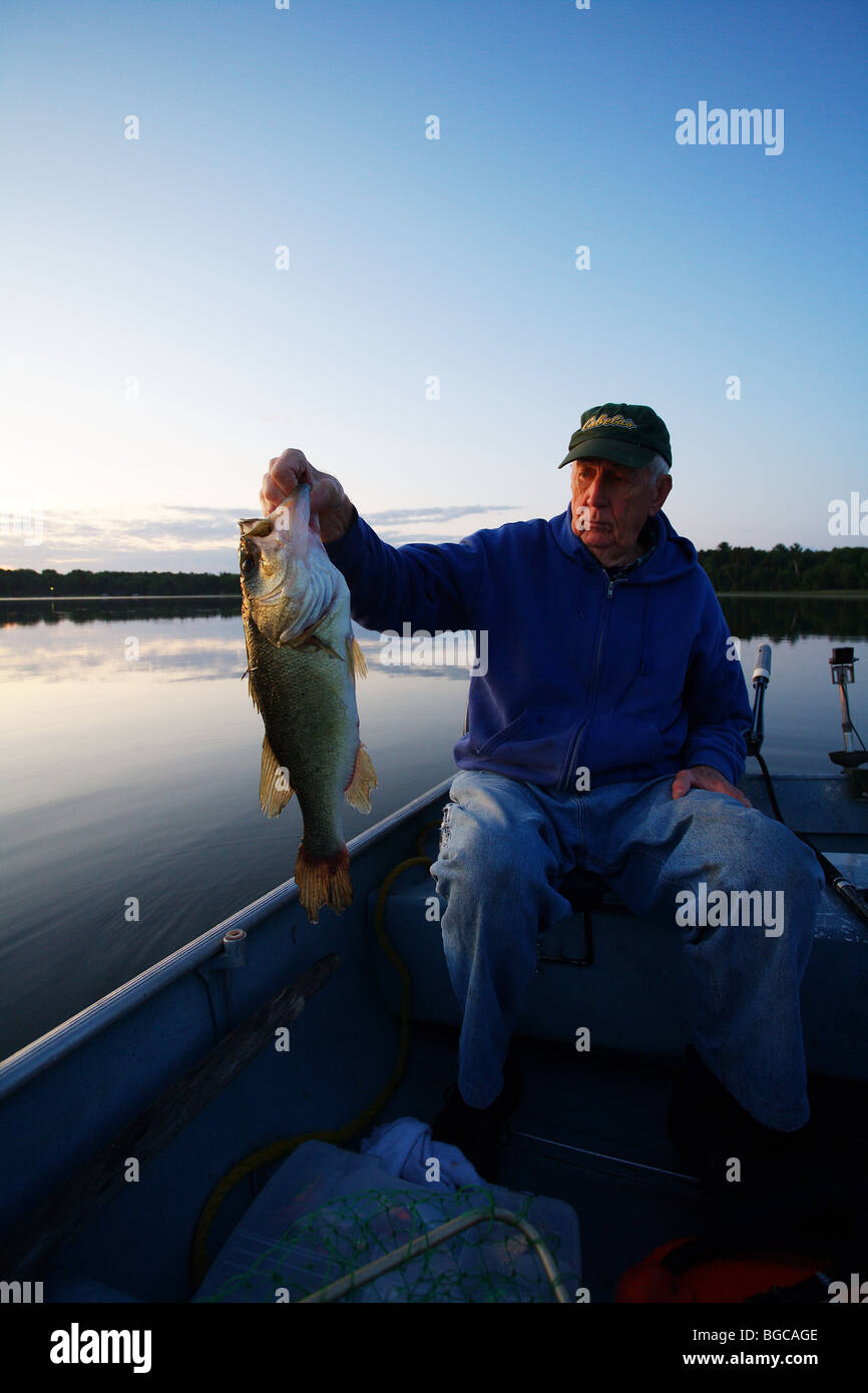 senior elderly fishing guide fisherman holding up monster five 5 pound ...
