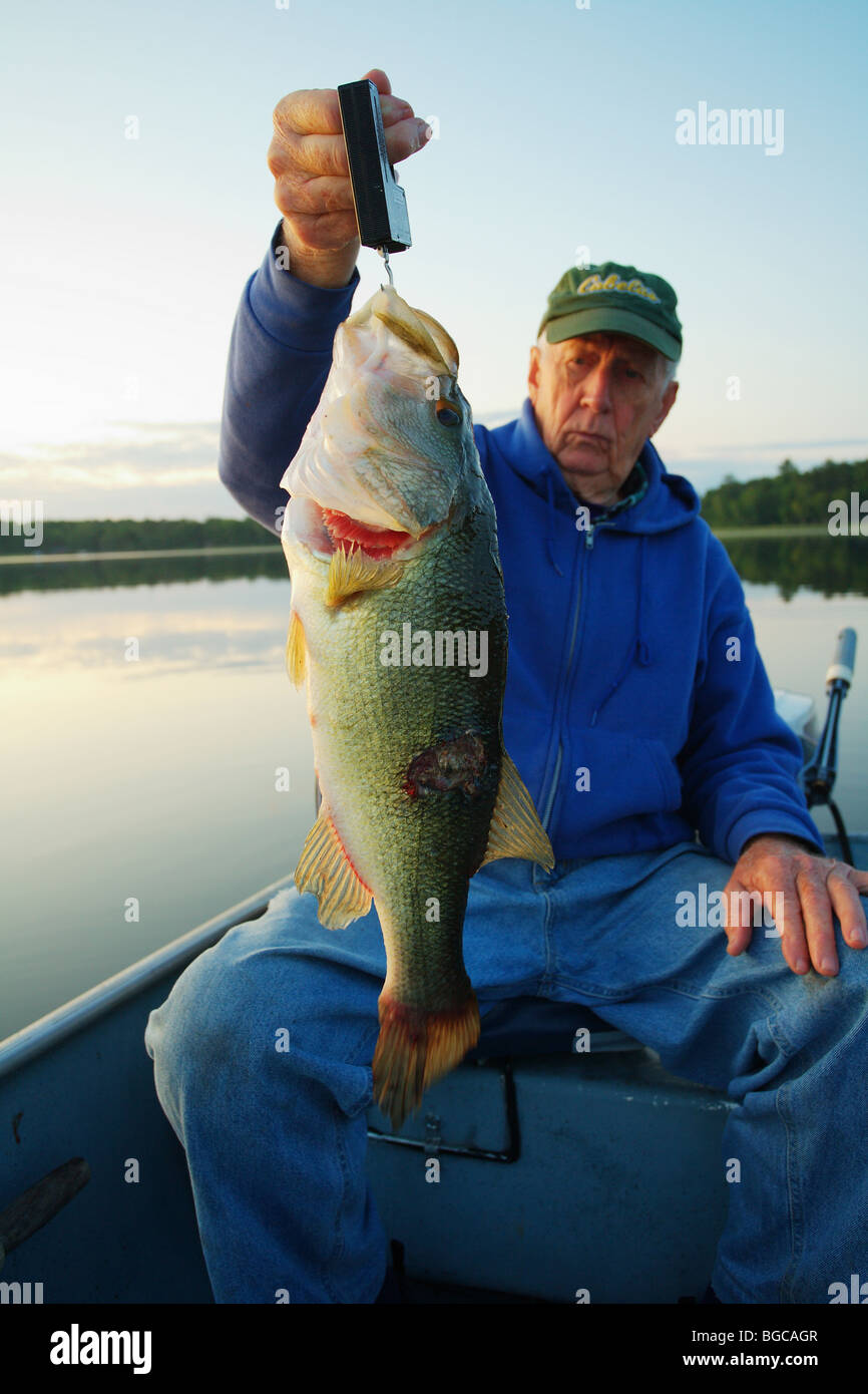 senior elderly fishing guide fisherman holding up monster five 5 pound ...
