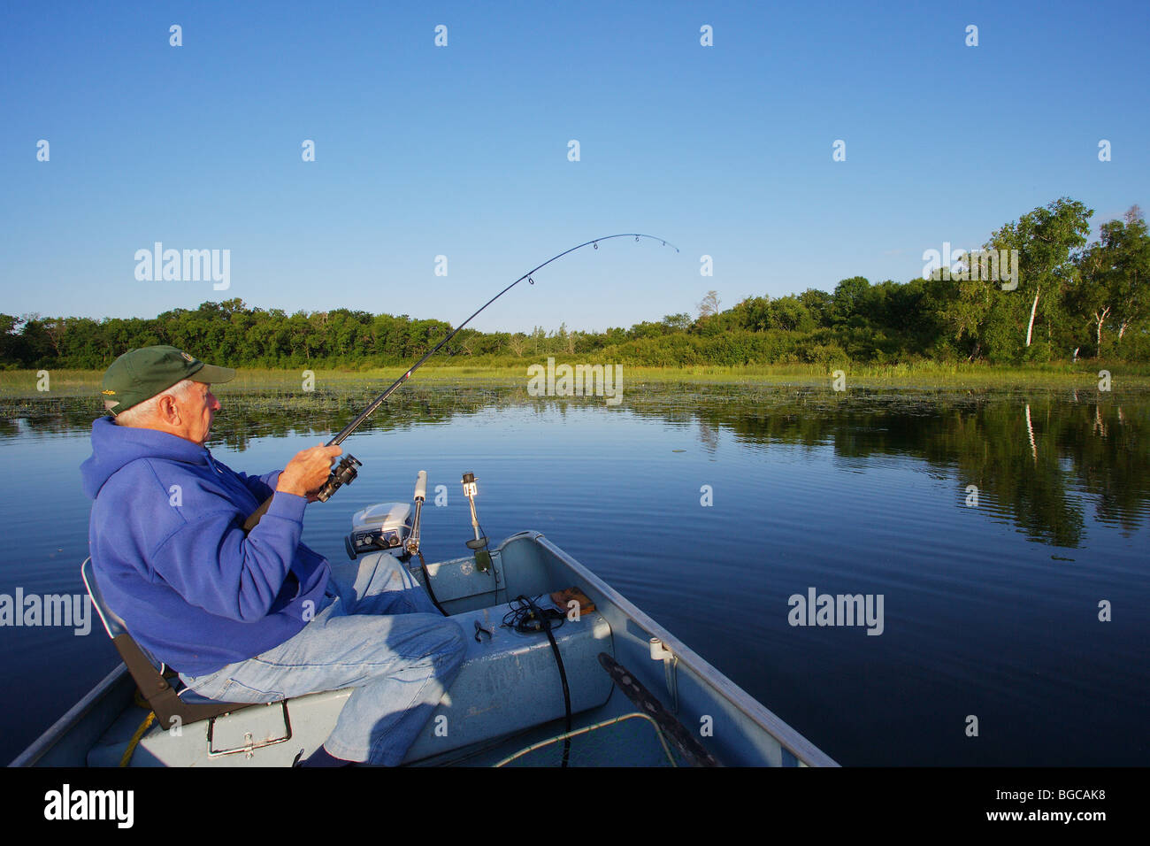 seasoned elderly senior fishing guide fishing in alumnacraft boat Stock ...