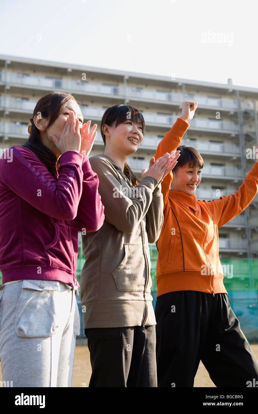 Three woman cheering Stock Photo - Alamy