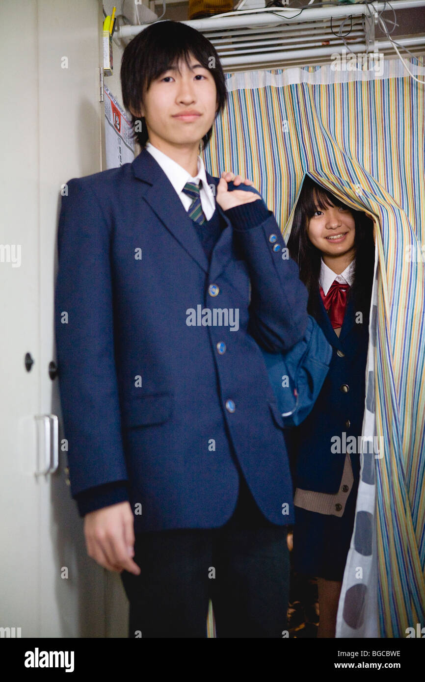Teenage boy and girl standing Stock Photo - Alamy