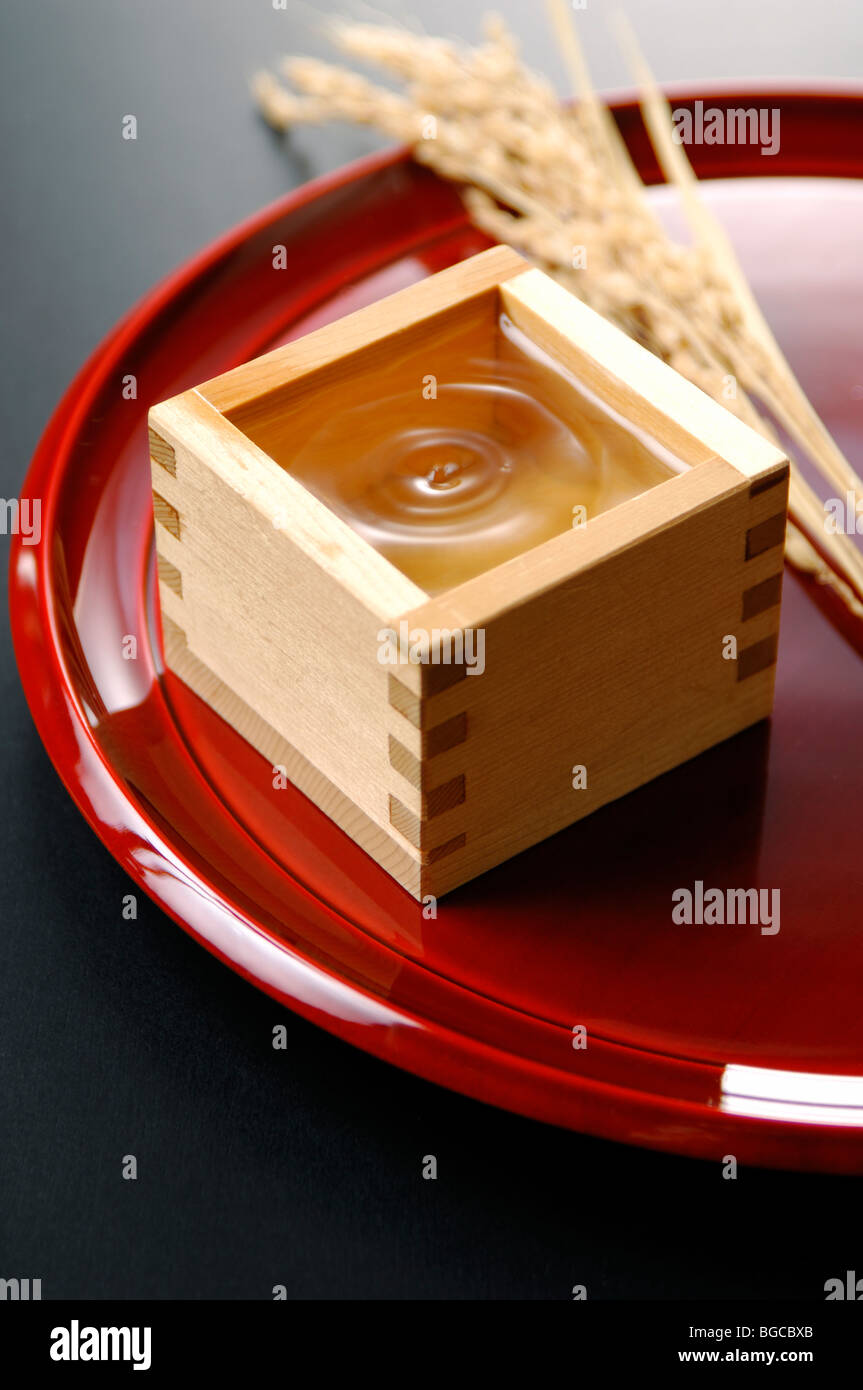 Sake in small wooden box Stock Photo - Alamy