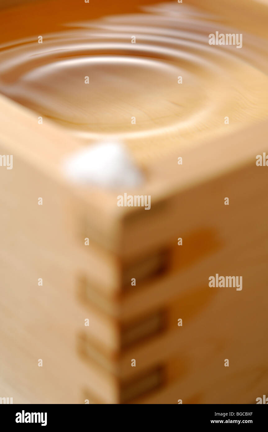 Sake in small wooden box Stock Photo - Alamy