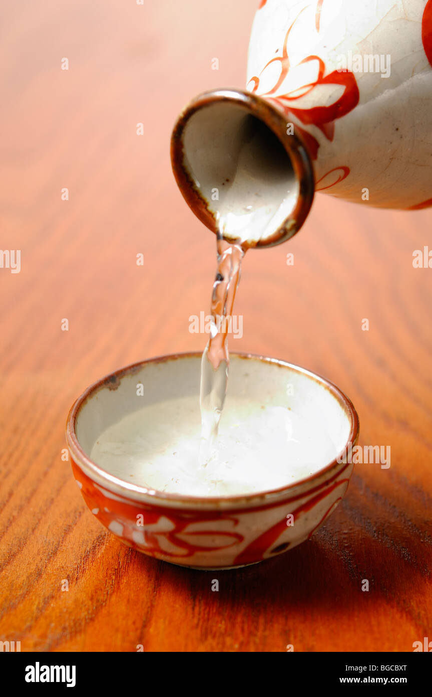 Sake pouring into sake cup Stock Photo - Alamy