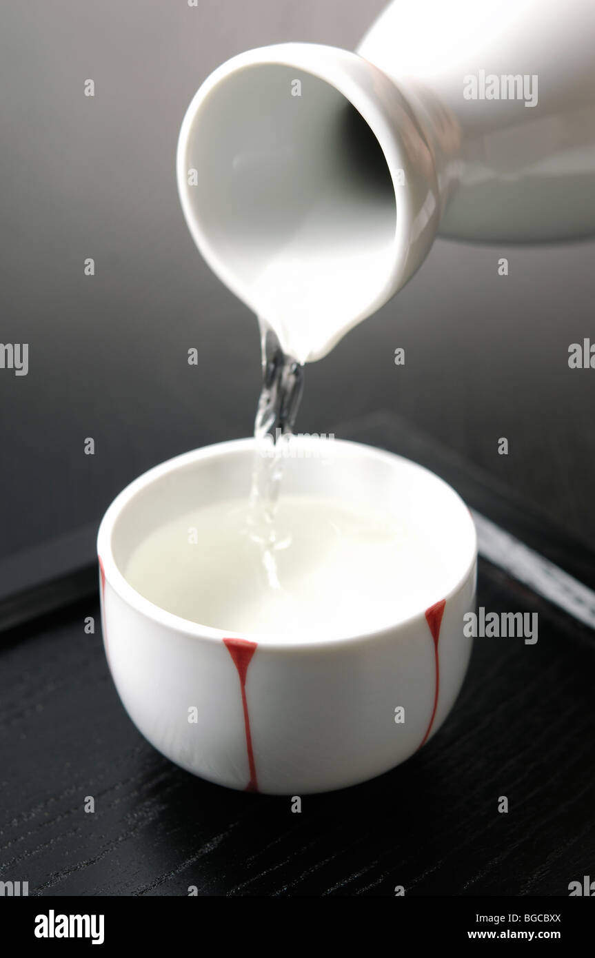 Sake pouring into sake cup Stock Photo - Alamy