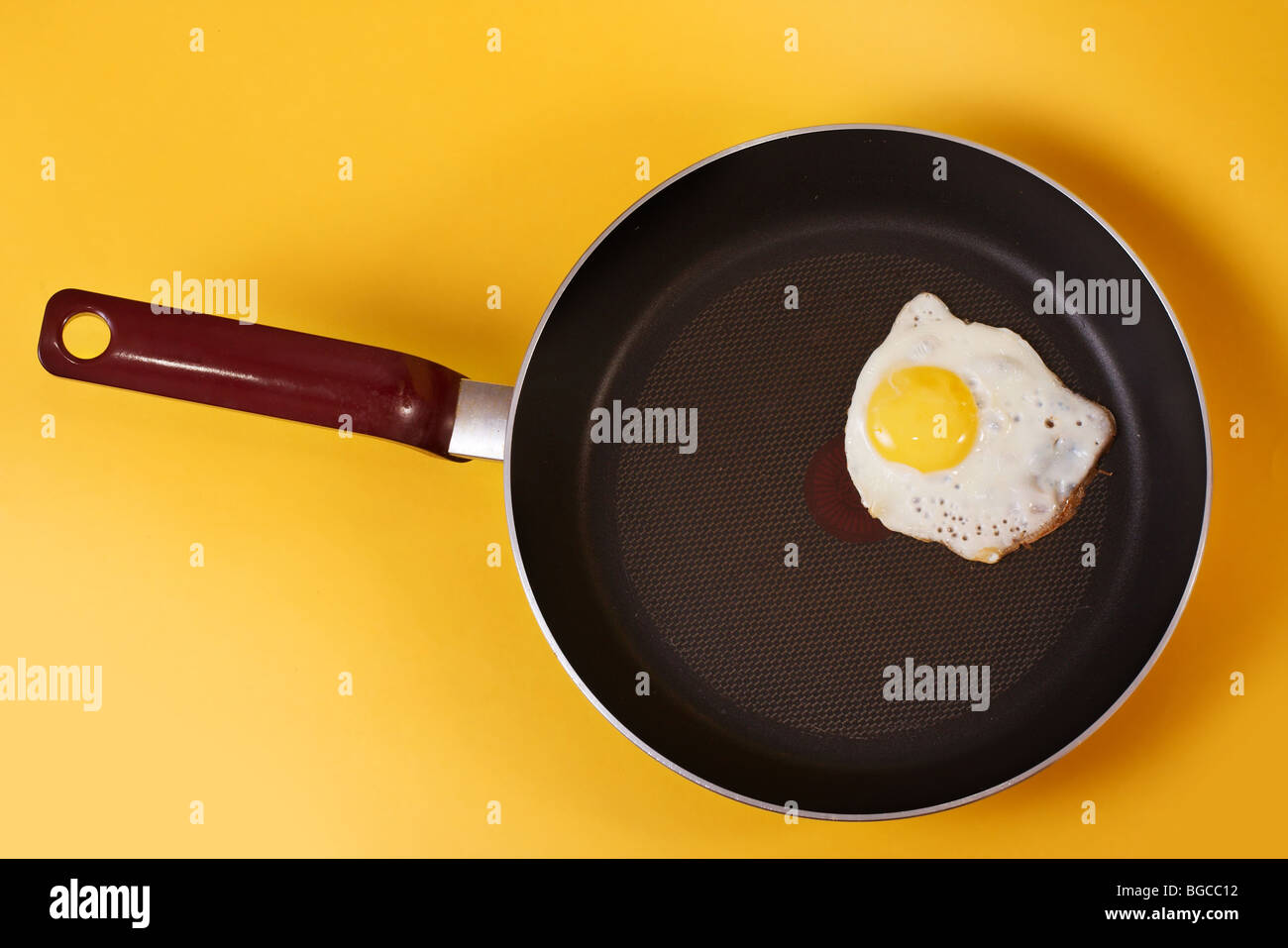 omelet in the griddle on yellow background Stock Photo - Alamy
