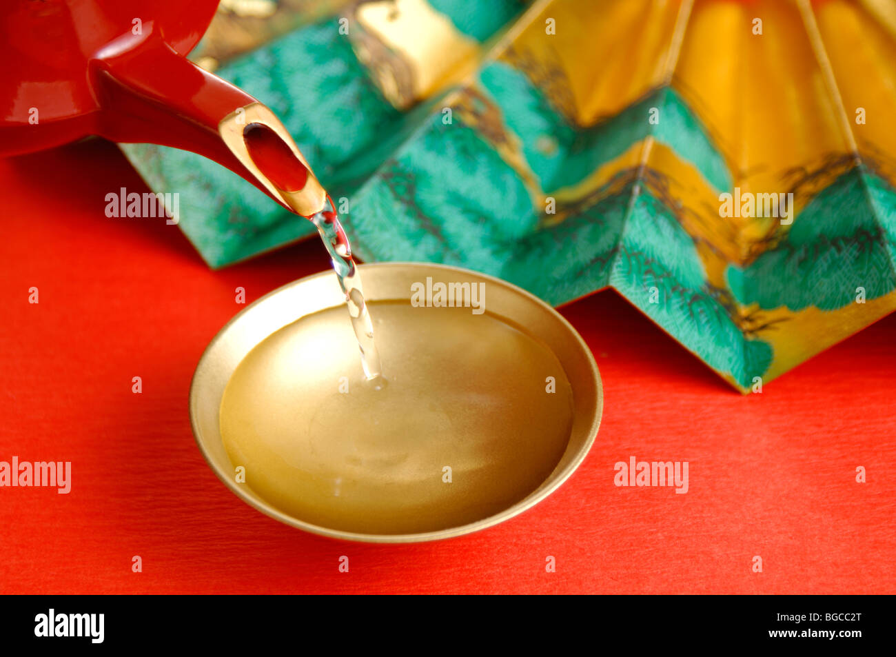 Spiced sake pouring into sake cup Stock Photo - Alamy