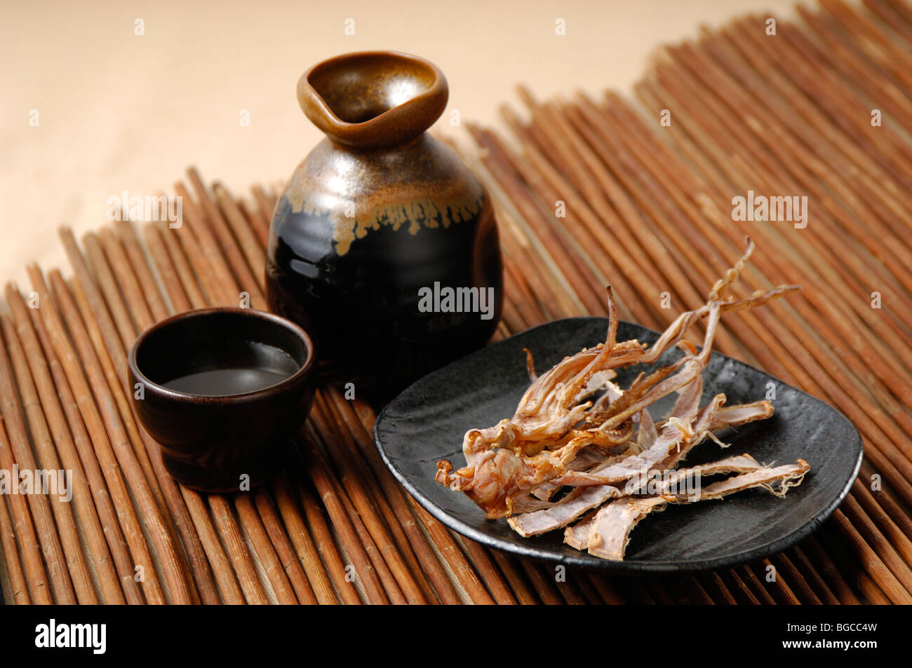 Shochu and dried squid Stock Photo - Alamy