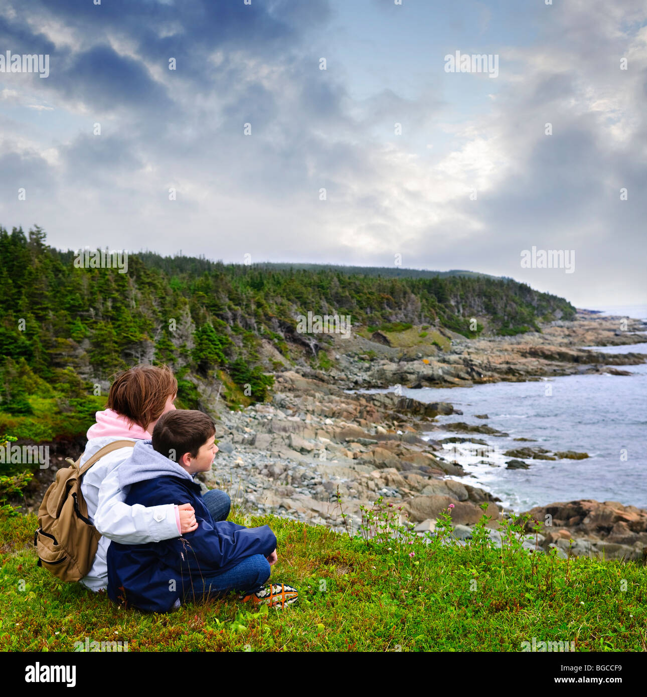 Children looking at coastal view of rocky Atlantic shore in ...