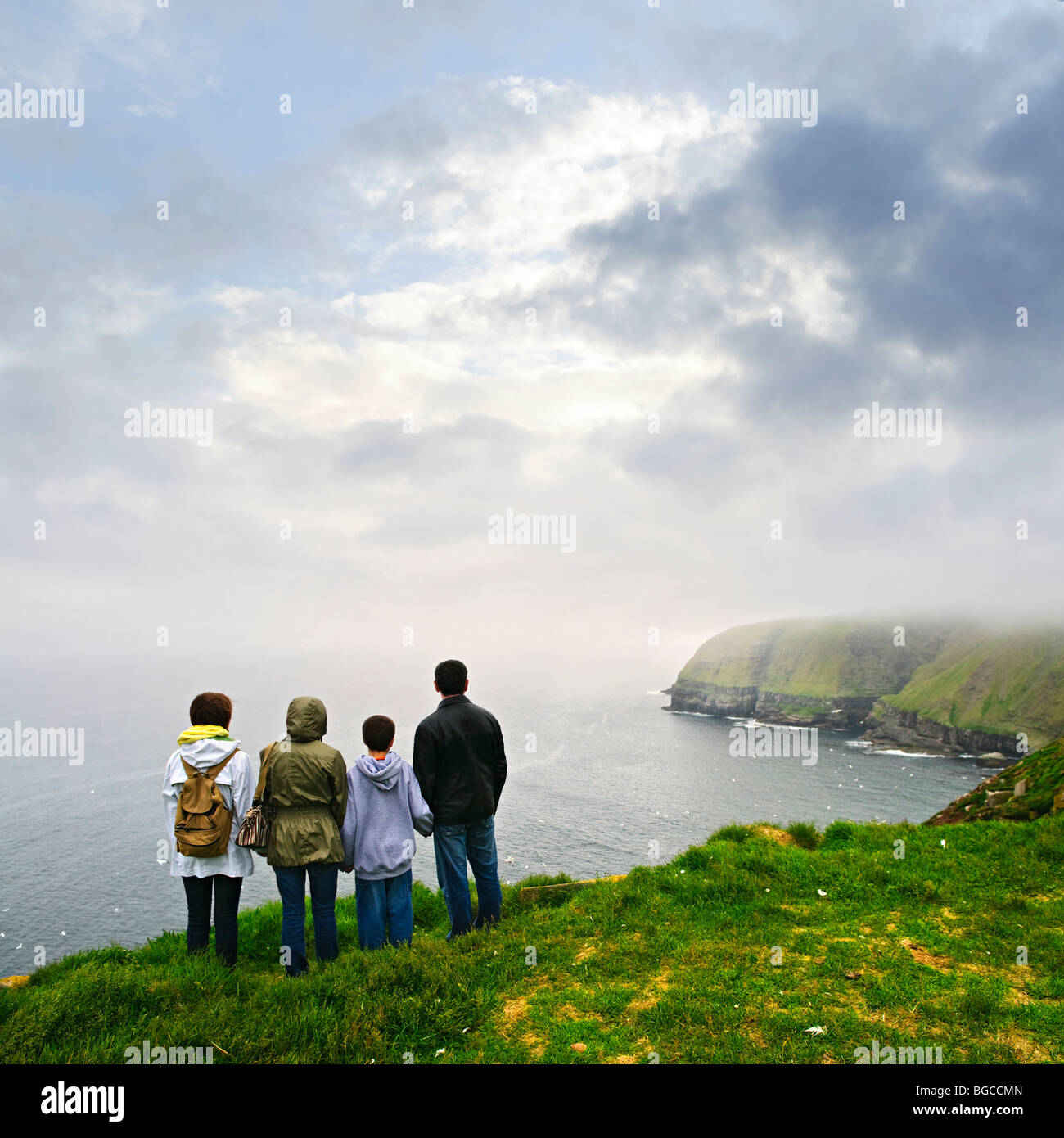 Family looking from cliff at Cape St. Mary's Ecological Bird Sanctuary ...