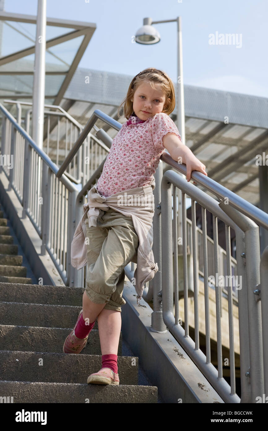 Young girl standing on steps Stock Photo - Alamy