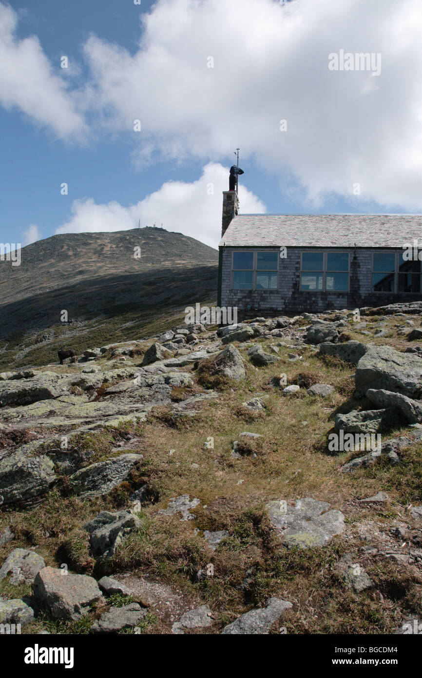 Lakes of the Clouds Hut crew working on roof of hut with the summit of ...