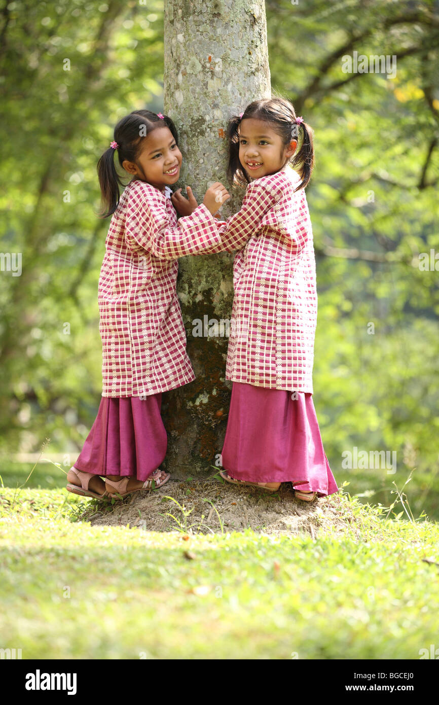 Twin sisters are playing in the park Stock Photo - Alamy