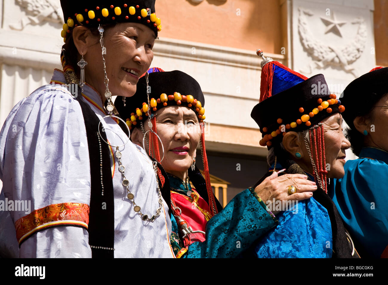 Three Mongolian women in traditional costume on the steps of the State ...