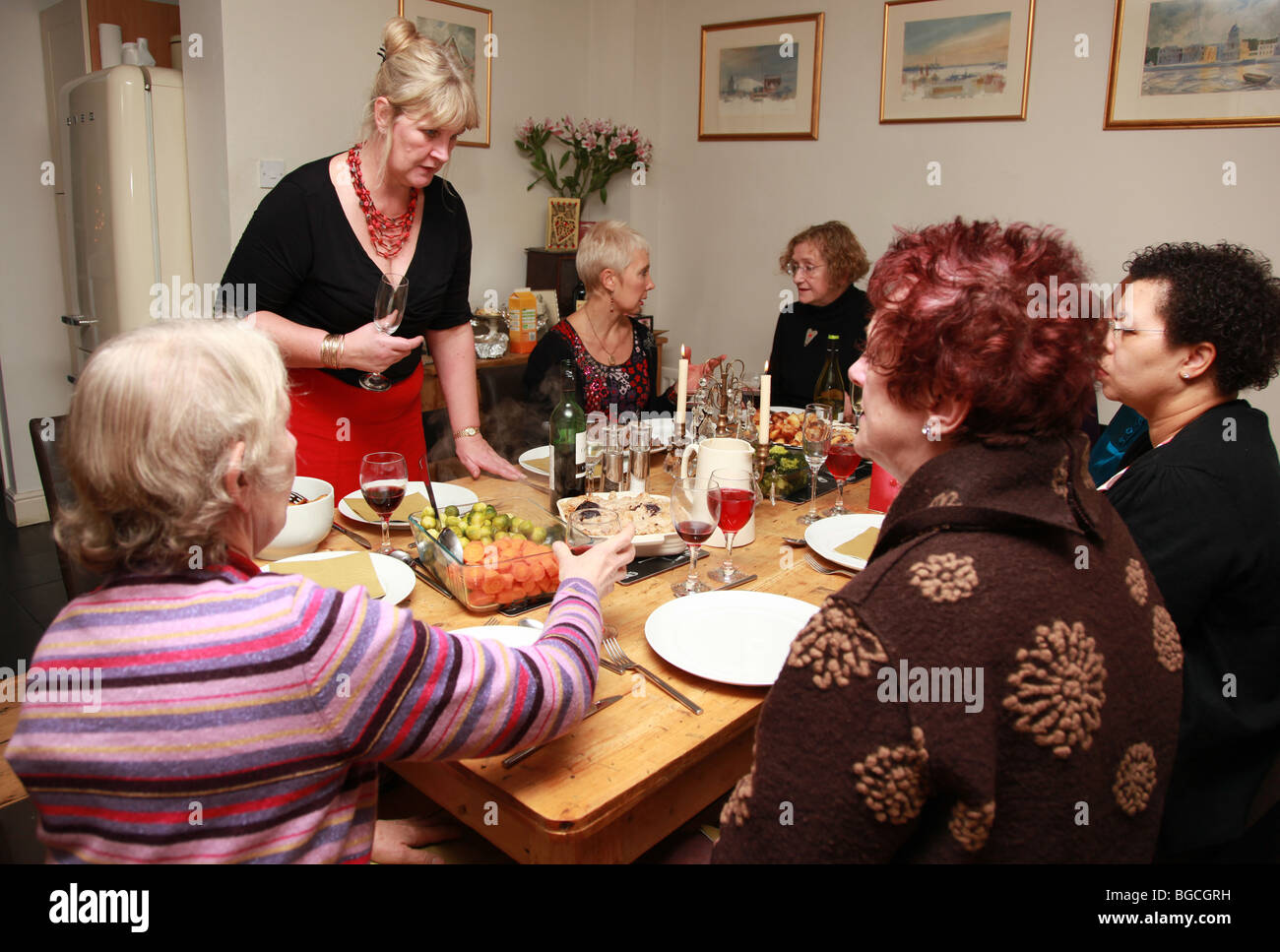 Group of adults having dinner together Stock Photo - Alamy