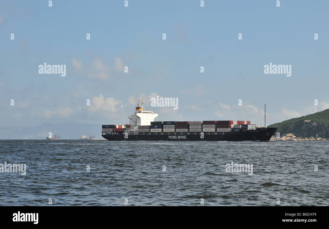 Yang Ming container ship, YM Earth, sailing west along the East Lamma Channel, towards the port ...