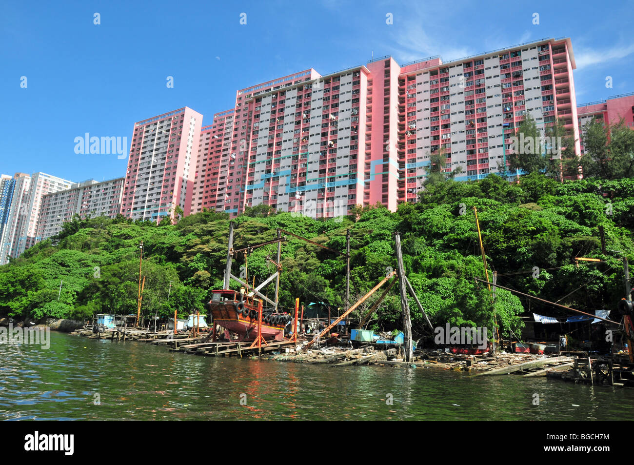 Stern view of a sampan under repair at an open air, boat building yard ...