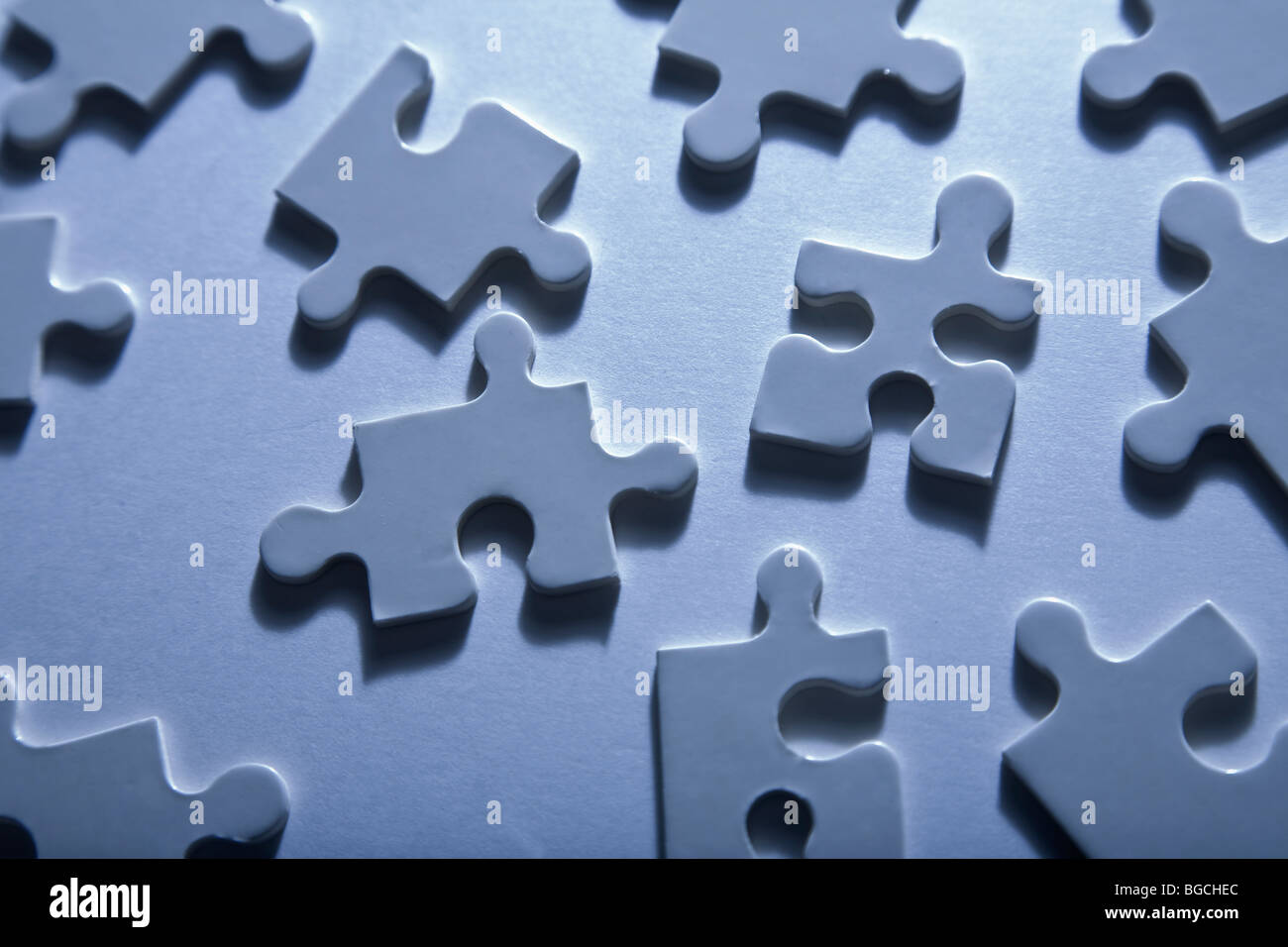 Backlit jigsaw puzzle pieces at random as a nice background Stock Photo ...