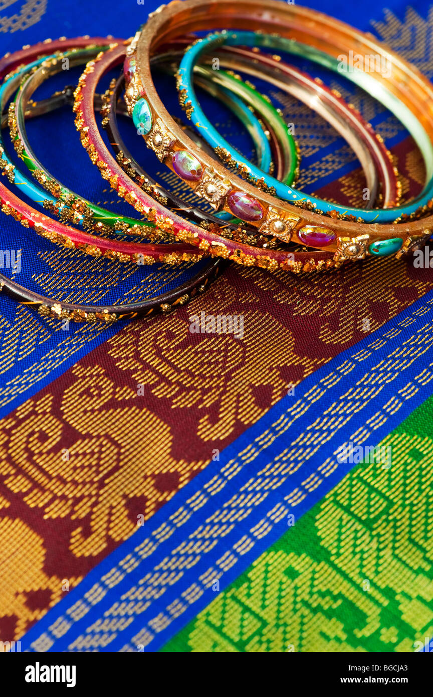 Colourful indian silk sari showing border pattern and ladies bangles ...
