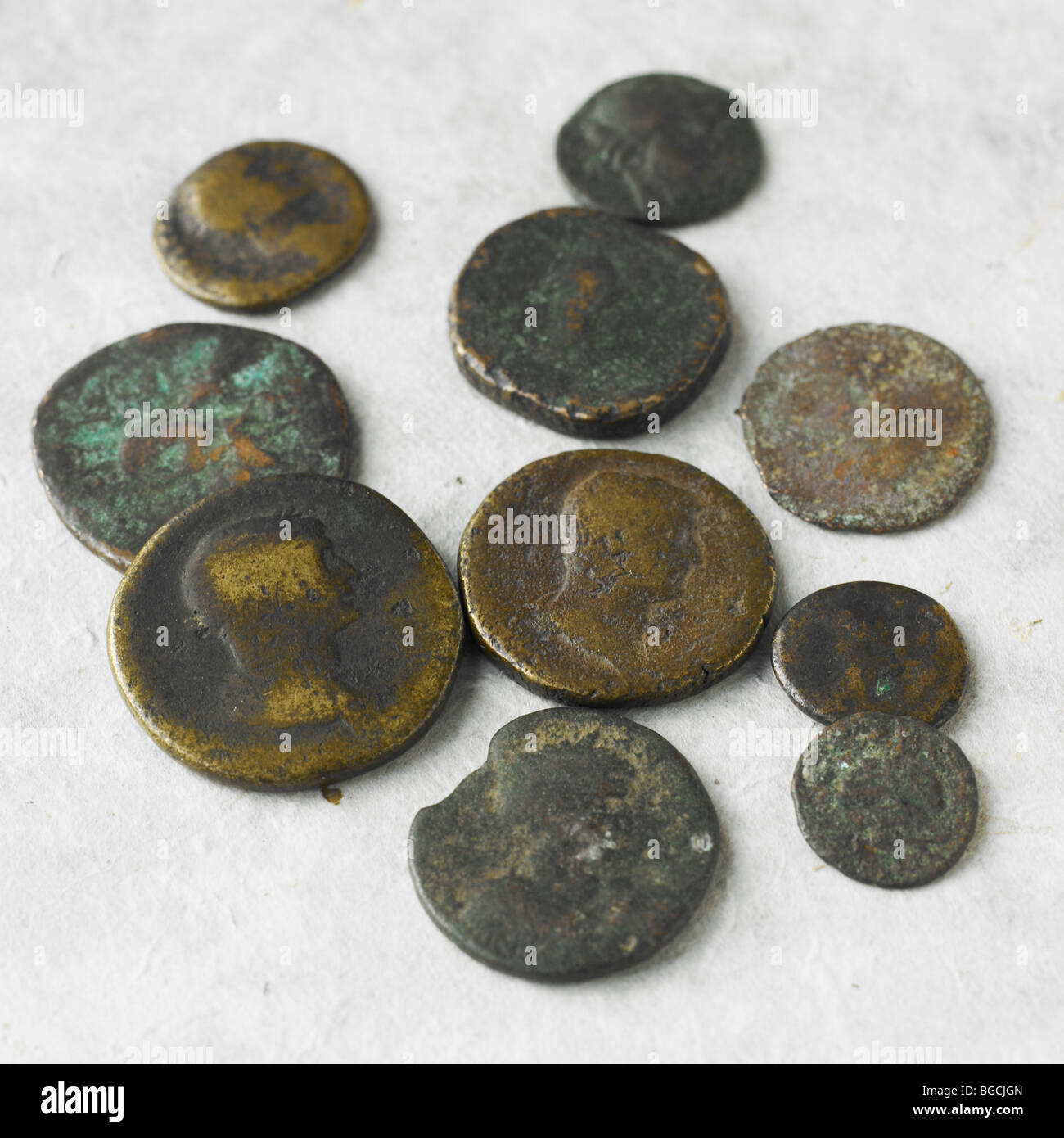 Ancient Roman coins on handmade paper background Stock Photo - Alamy