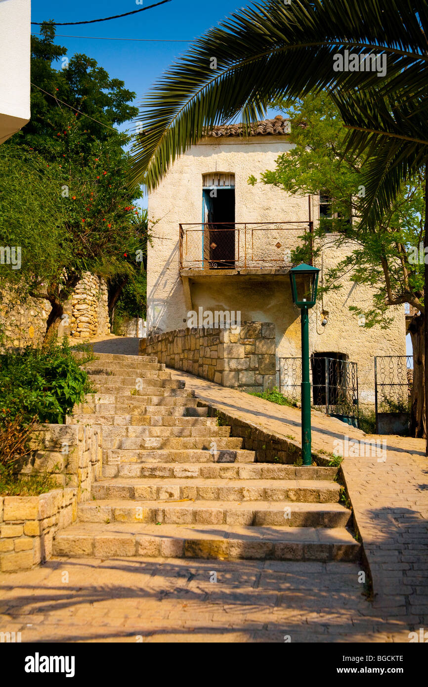 Well kept stone steps lead up and through a lane in a Greek village. A ...