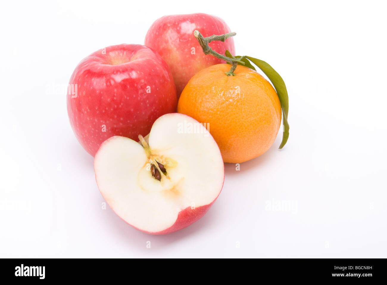 Pink Lady red apple with slice and clementine isolated against white ...