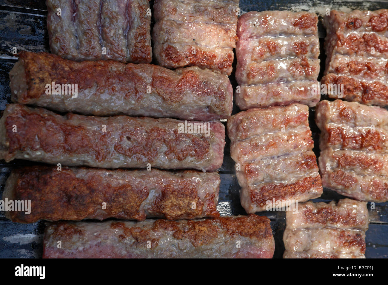 Barbecue. Minced meat roasting on hot barbeque grill plate Stock Photo ...