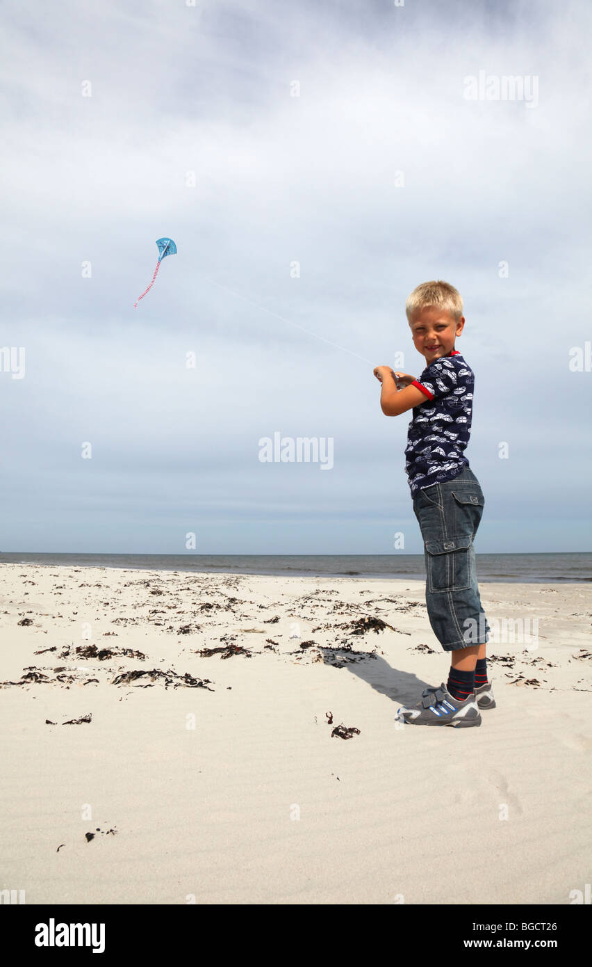young boy smiling flying his kite Stock Photo - Alamy