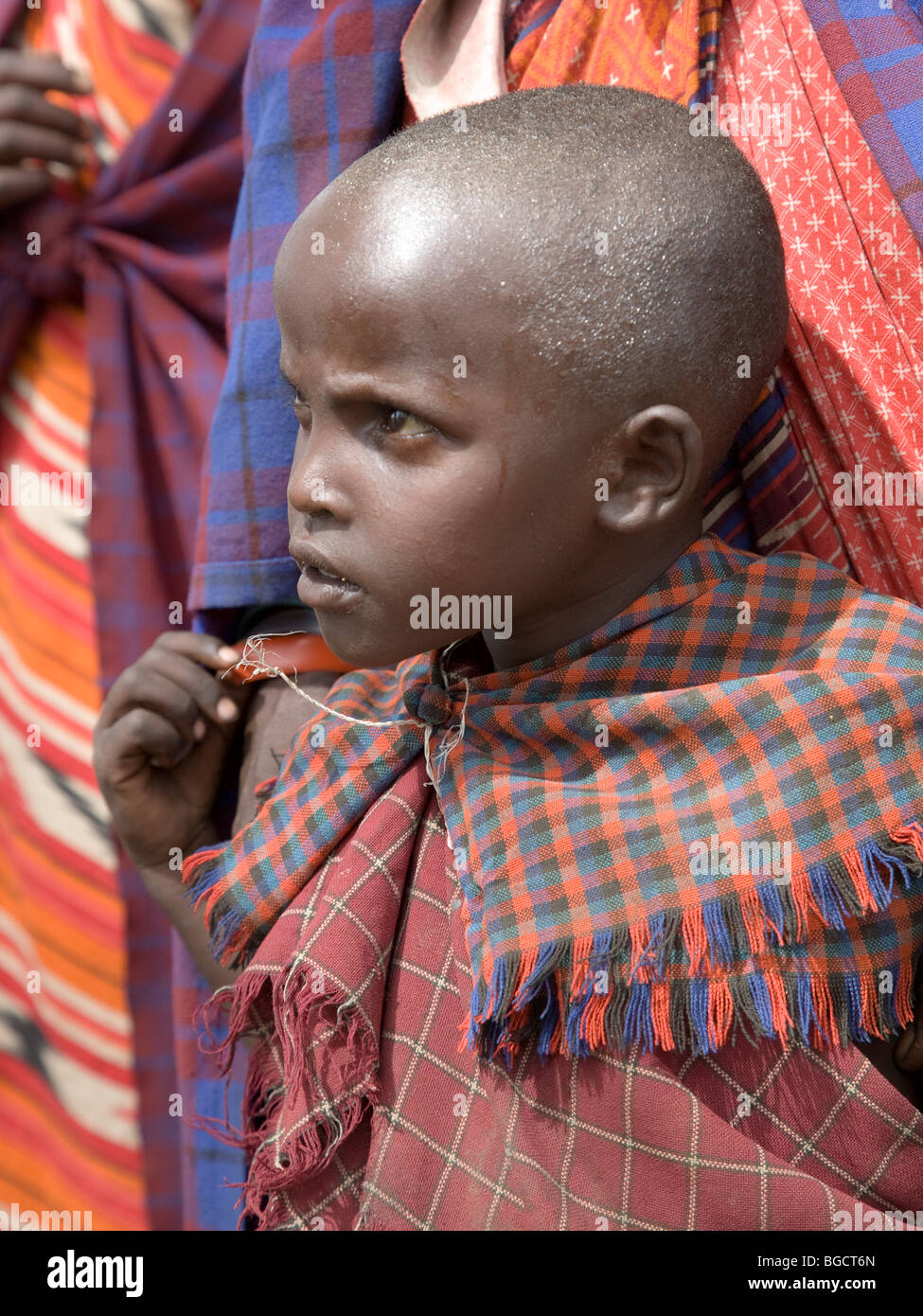 Young Maasai boy close up in profile and in tribal costume gazing ...