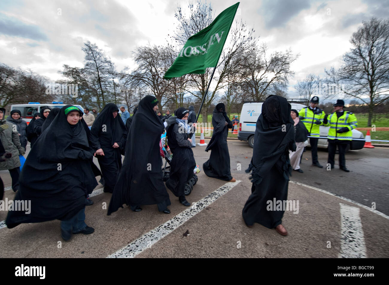 A group of Shia Muslim women with flags and banners take part in the ...