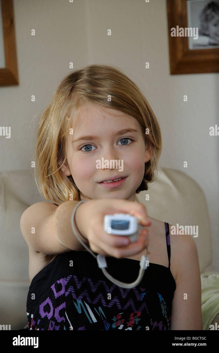 Portrait of a young girl using a Wii game controller Stock Photo - Alamy