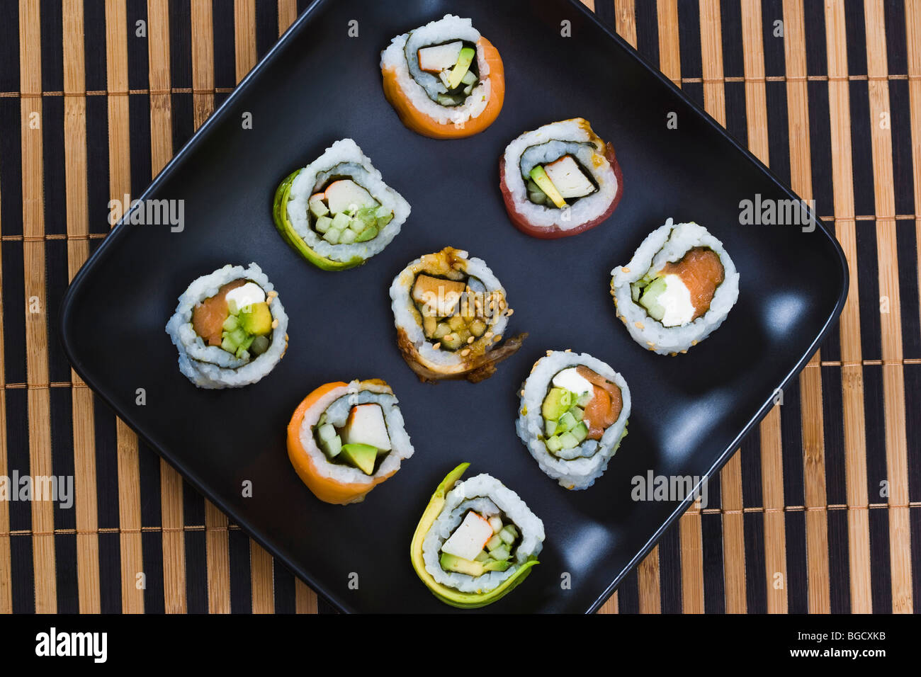 Assorted sushi rolls on black plate, close up Stock Photo - Alamy
