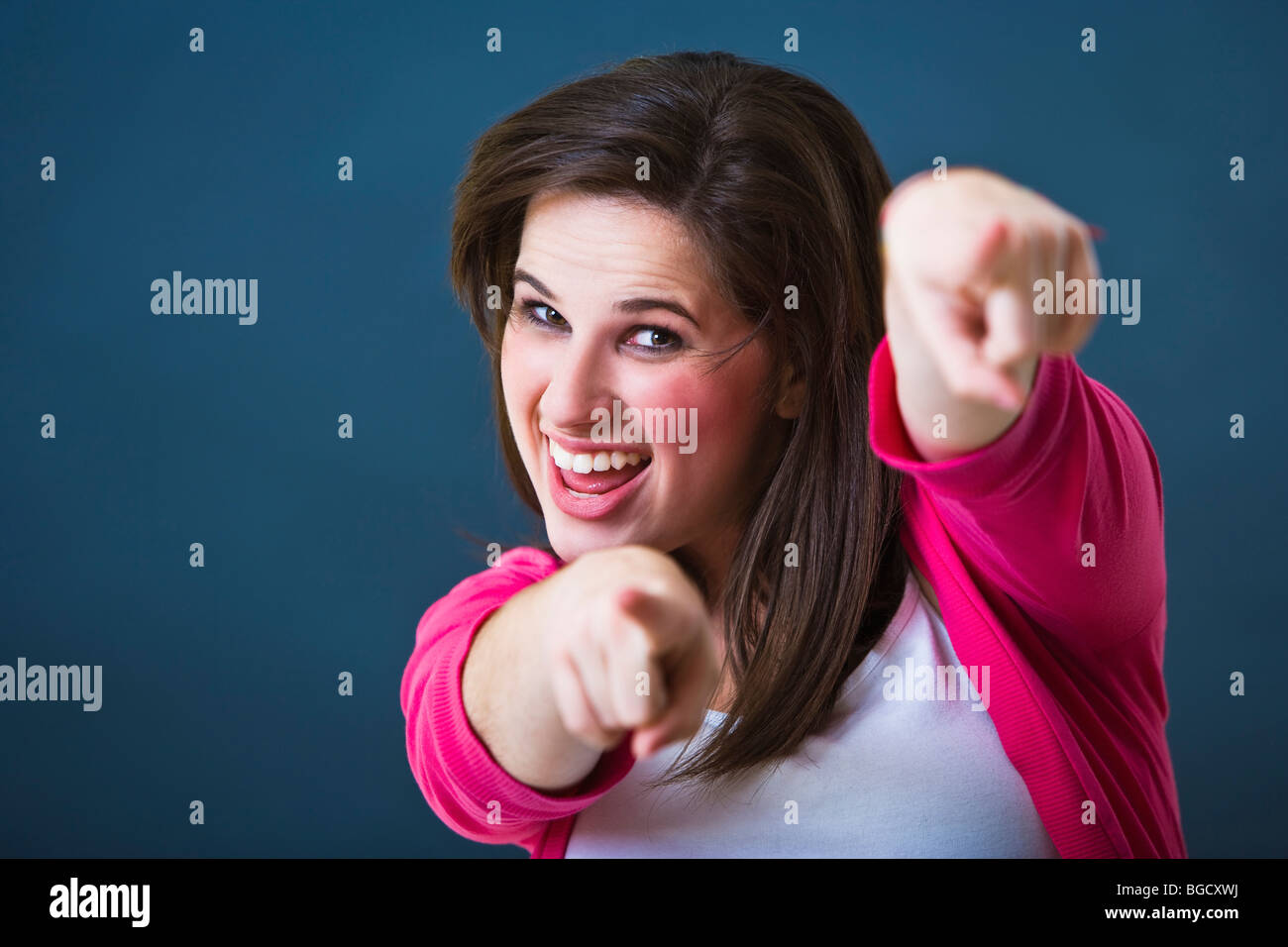 Young woman laughing and point to camera Stock Photo - Alamy