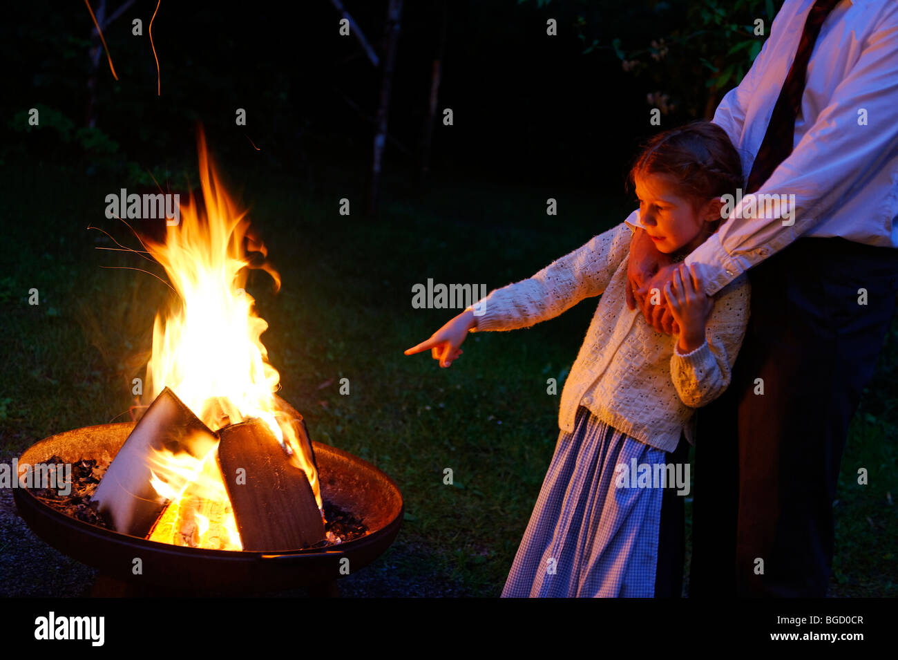 Girl in front of a fire Stock Photo - Alamy